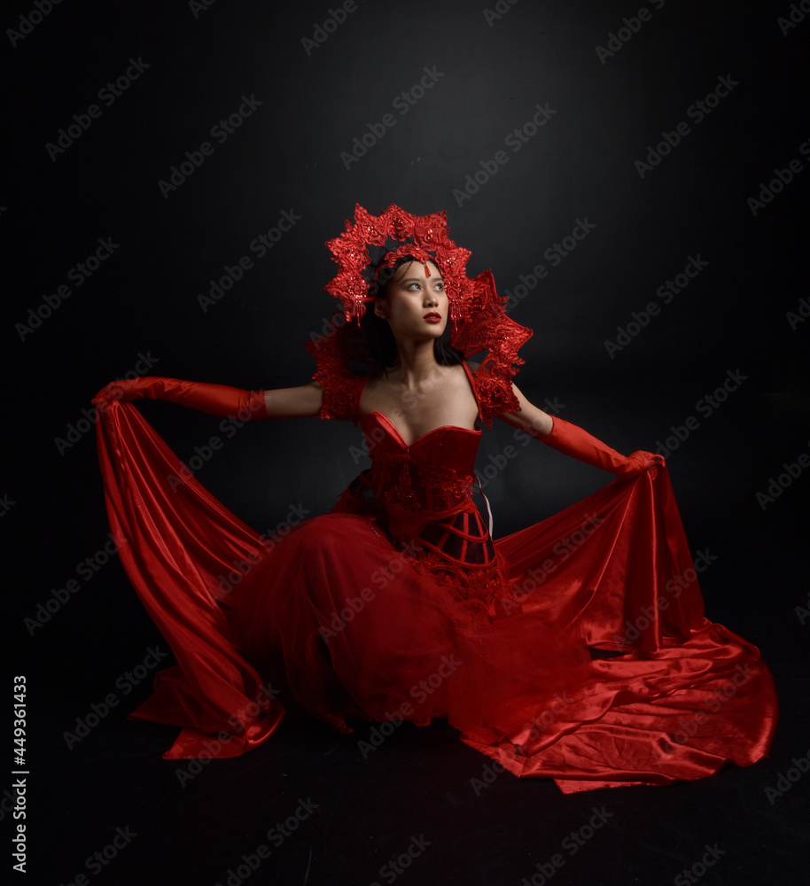 Full length portrait of beautiful young asian woman wearing red corset ...