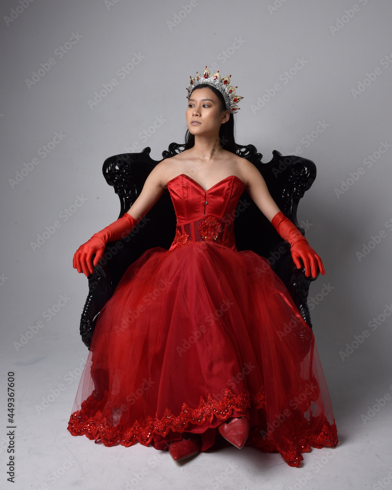 Full length portrait of beautiful young asian woman wearing red corset ...