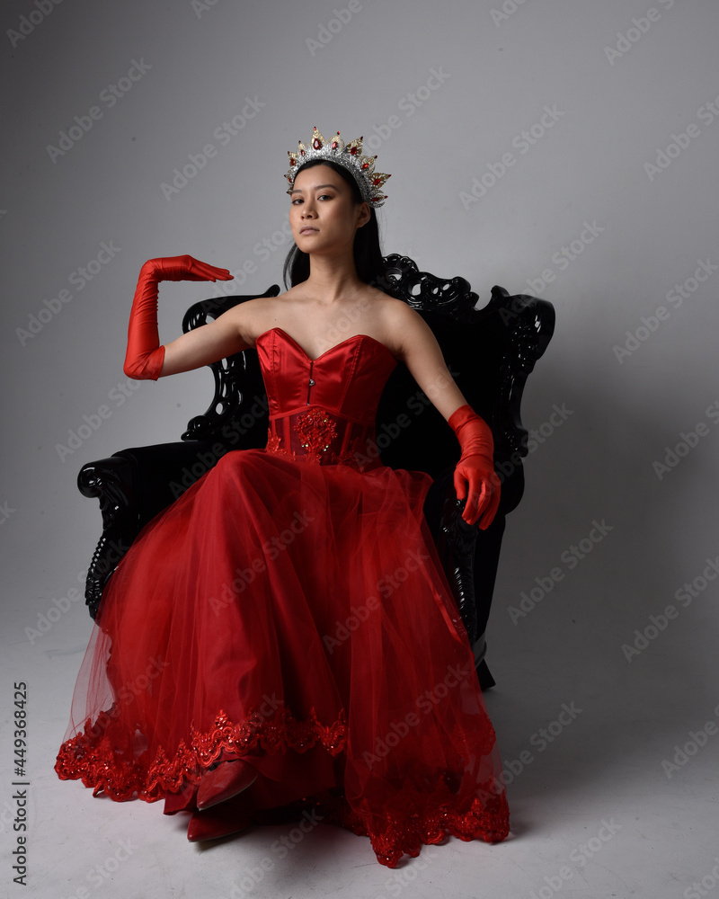 Full length portrait of beautiful young asian woman wearing red corset ...