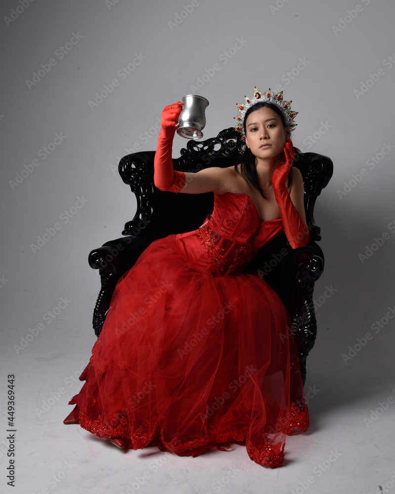 Full length portrait of beautiful young asian woman wearing red corset ...