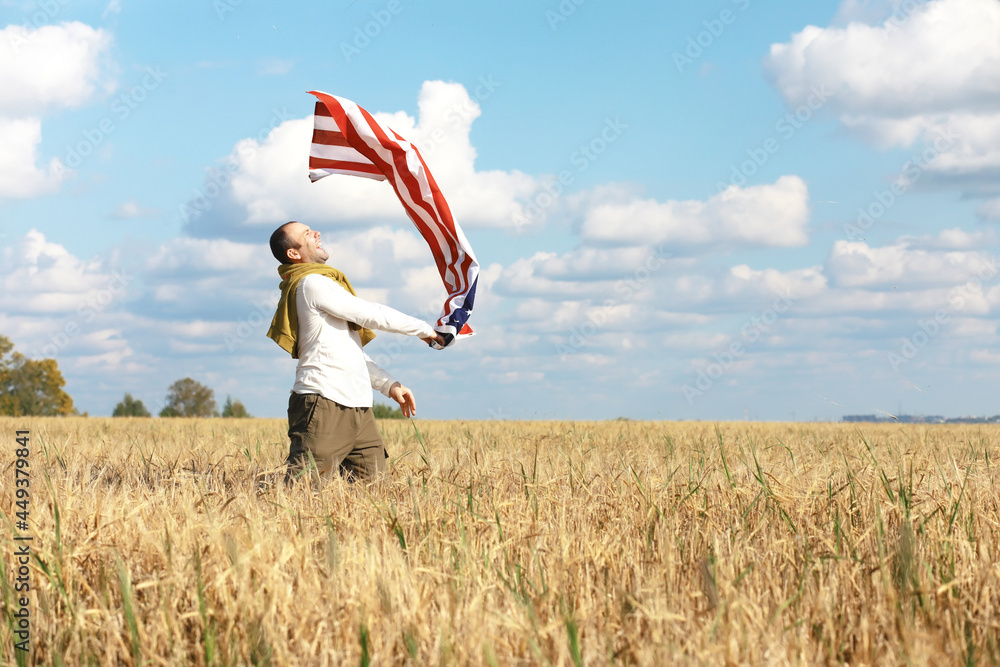 Man waving American flag standing in grass farm agricultural field ...