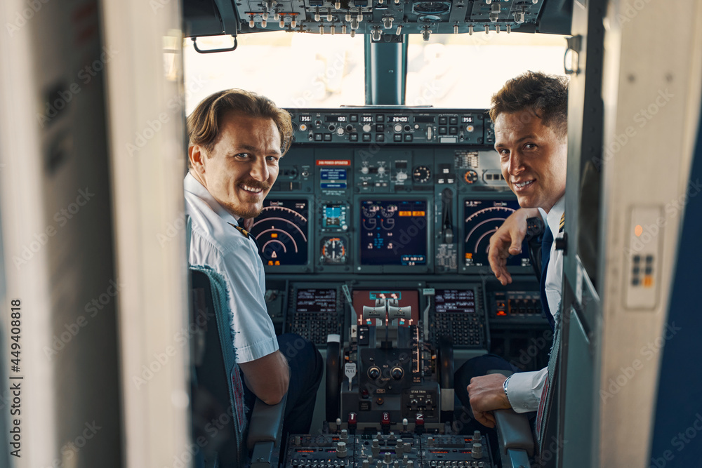 Joyous pilot and a co-pilot looking out of the cockpit Stock Photo ...