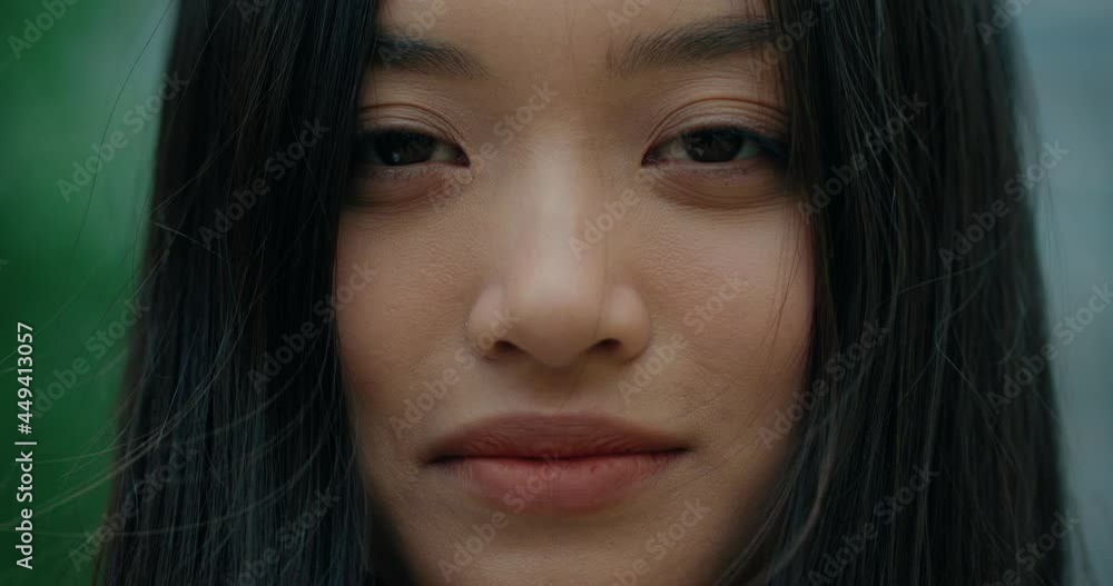 Portrait Face of Girl with Asian Appearance looking into camera ...