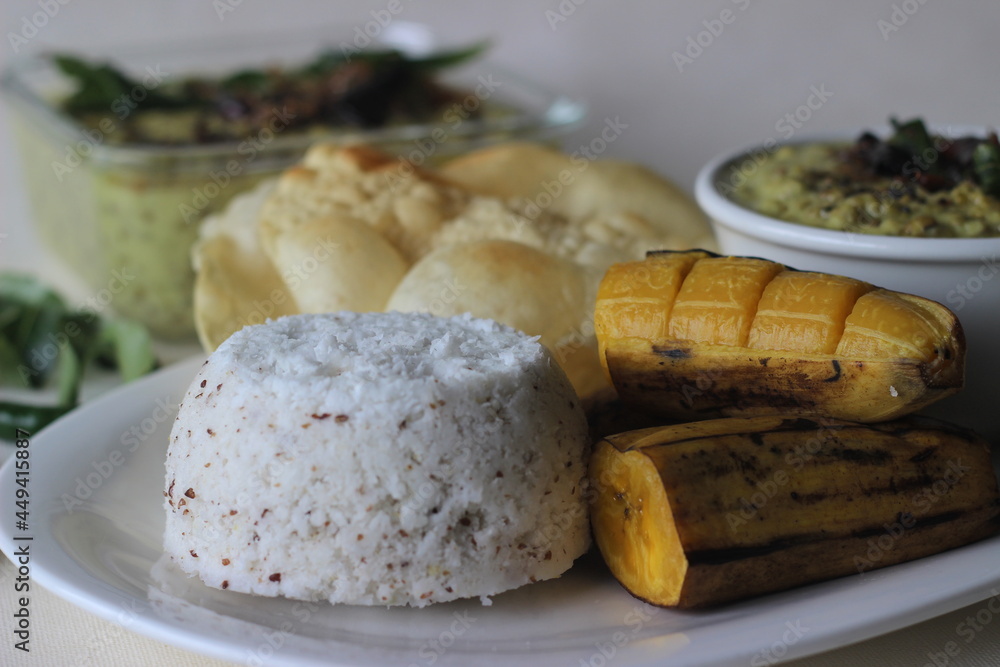 Steamed rice cake served with steamed plantain, green gram curry and ...
