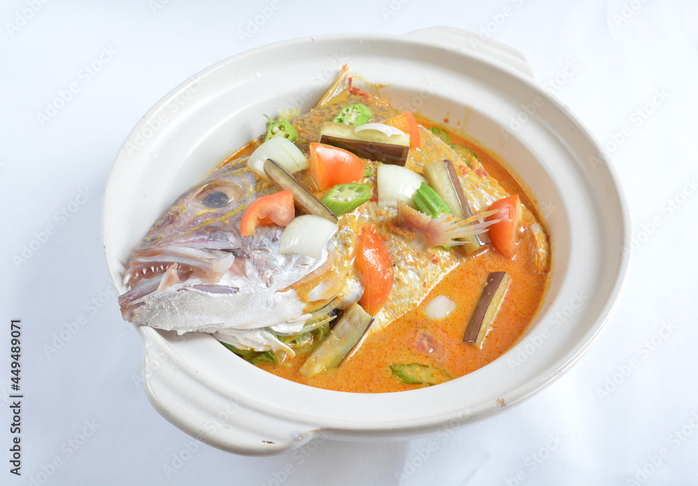 local spicy chilli curry soup big grouper fish head with vegetables in ...