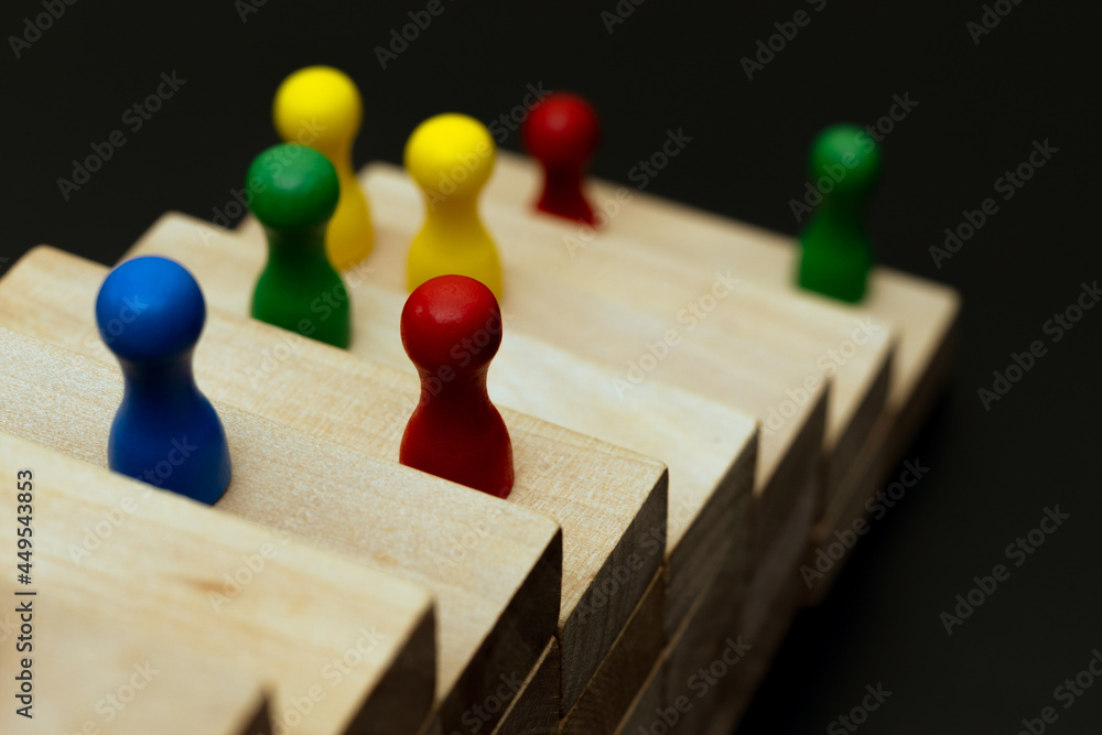 Miniature multi colored figurines on the career ladder of success ...