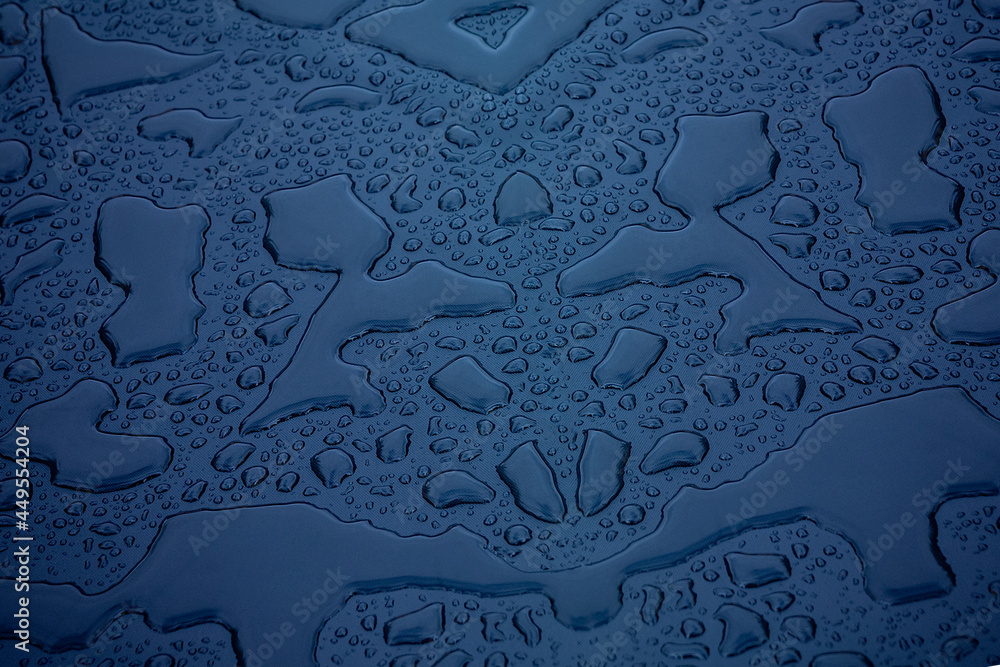 water droplets blue background showing surface tension on a hydrophobic ...