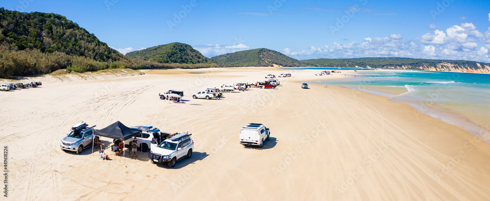 4WD vehicles and surfers at Double Island Point on a sunny day Stock ...