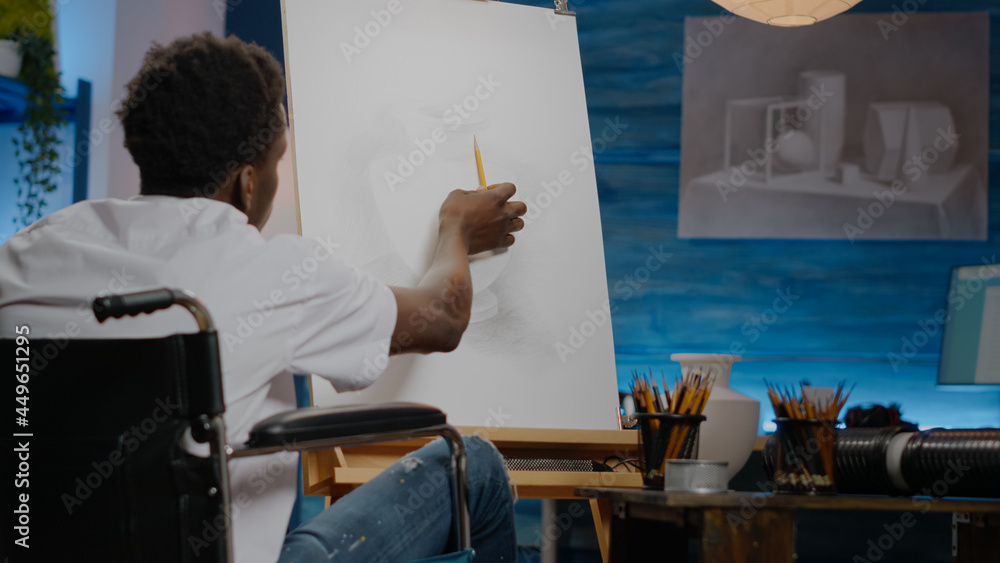 African american disabled young artist drawing vase on canvas and easel ...
