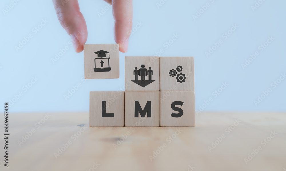 LMS Learning Management System concept. Hand holds wooden cube with LMS ...