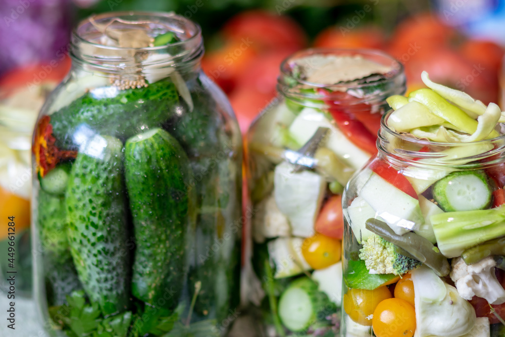 glass jars with different colors, types, shapes of vegetables ...