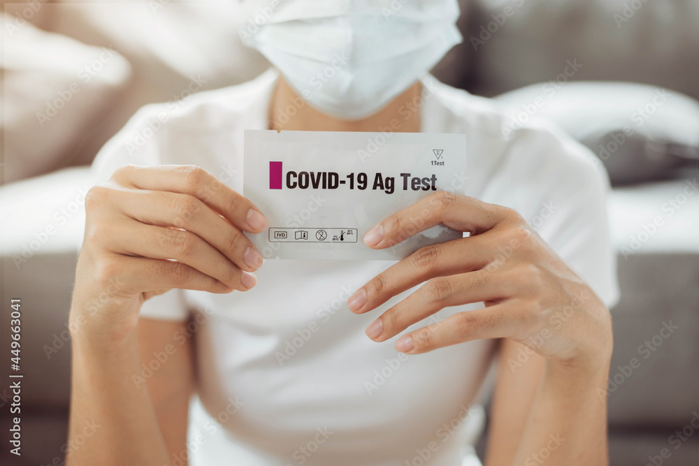 Woman self test for COVID-19 home test kit. asian woman using ...