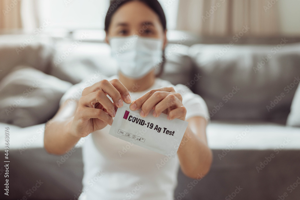 Woman self test for COVID-19 home test kit. asian woman using ...