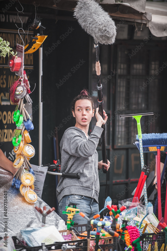 Behind the scene. Sound boom operator resting on the set and hold ...