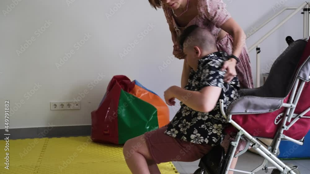 Mother with disabled child in big stroller. Accessibility of people in ...