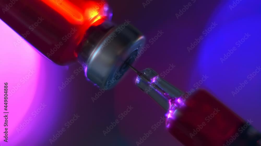 The needle of a glass modern syringe for vaccine injection takes ...