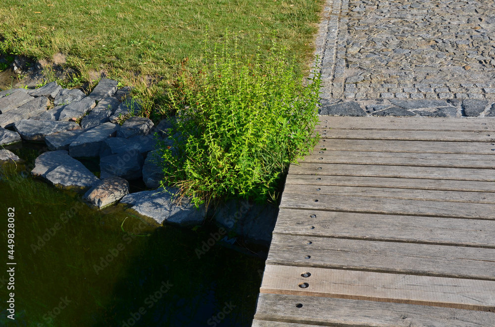 wooden wide pedestrian bridge over the river pond lake, without ...