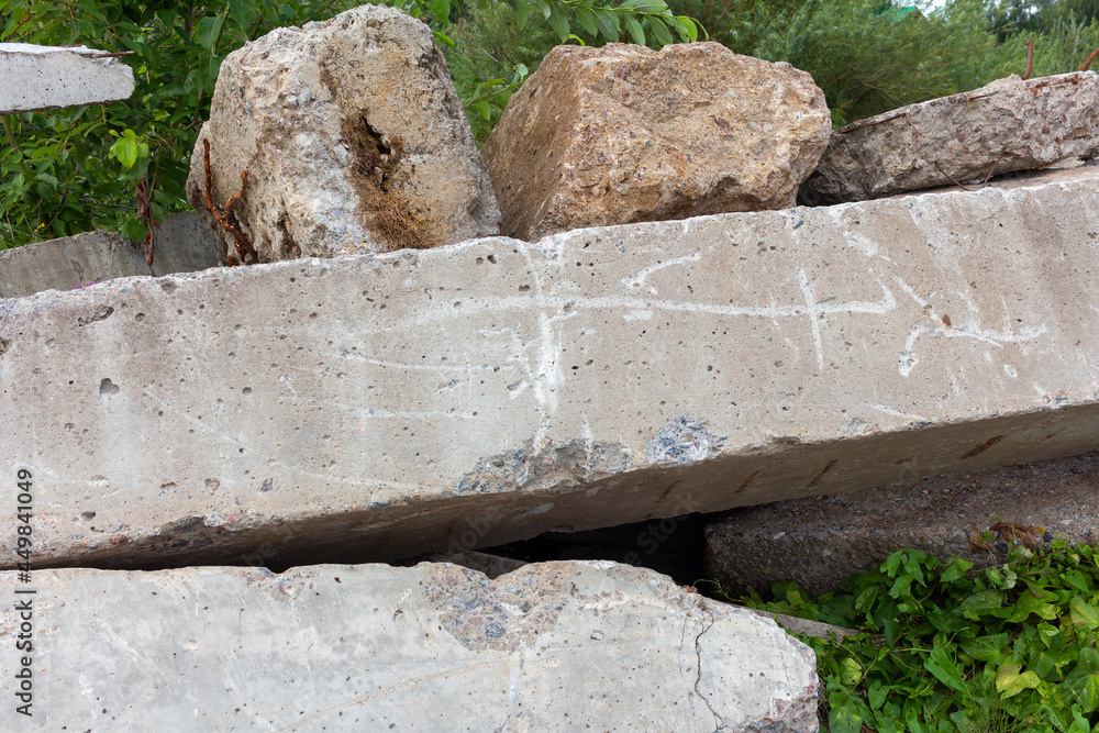 Damaged reinforced concrete blocks and slabs piled on the ground ...