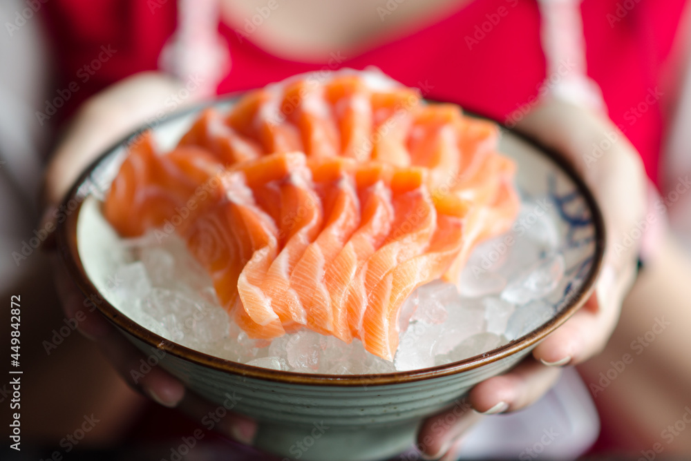 Salmon Sashimi in Japanese buffet restaurant menu.Asian people eating ...