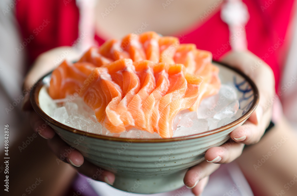 Salmon Sashimi in Japanese buffet restaurant menu.Asian people eating ...