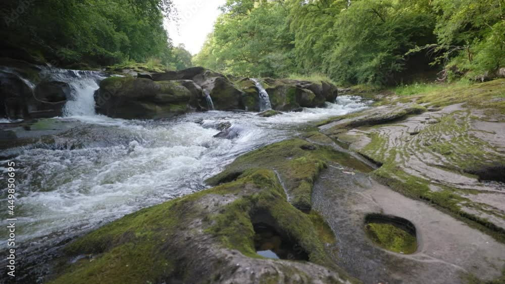 Beautiful rock formation in the middle of a flowing river that has ...