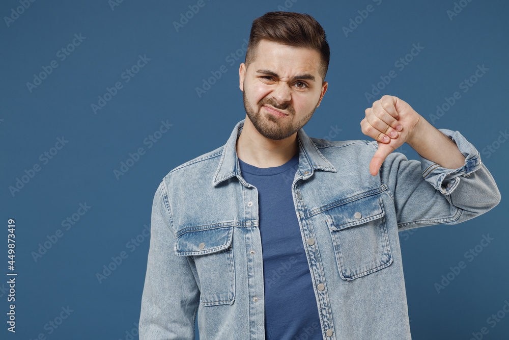 Frowning gloomy discontent disgruntled young brunet man 20s wears denim ...