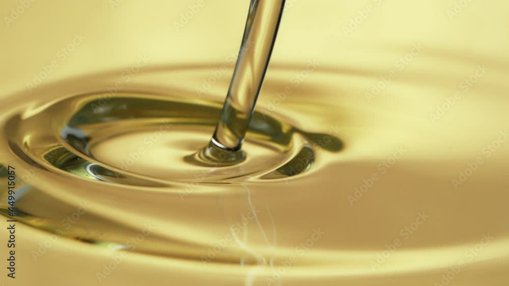 Super slow motion of pouring oil, macro shot. Filmed on high speed ...