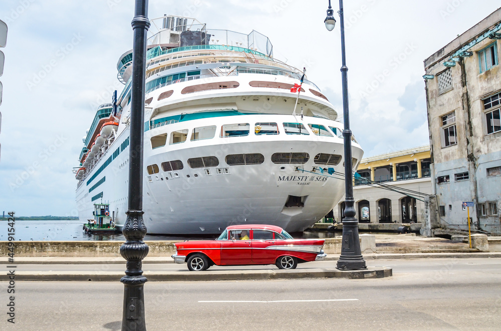 Old classic American car in Havana, Cuba driving by a Royal Caribbean ...