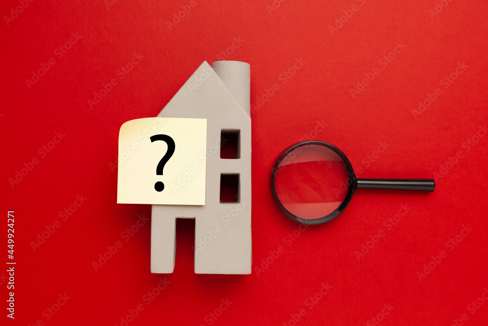 Real estate and question mark on a red background. Home inspection and ...