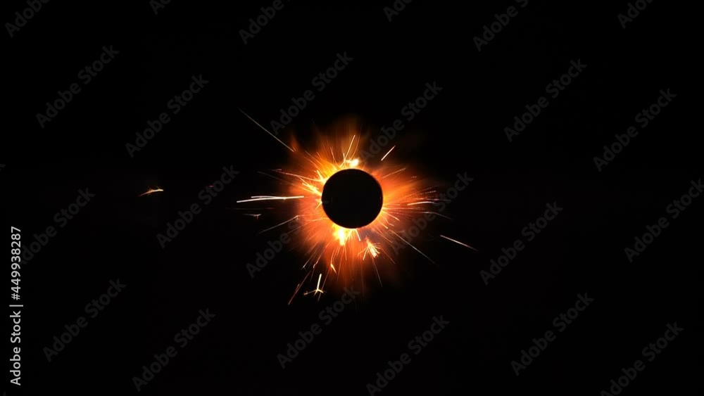 A black circle around which a corona of blue fire and bright sparks who ...