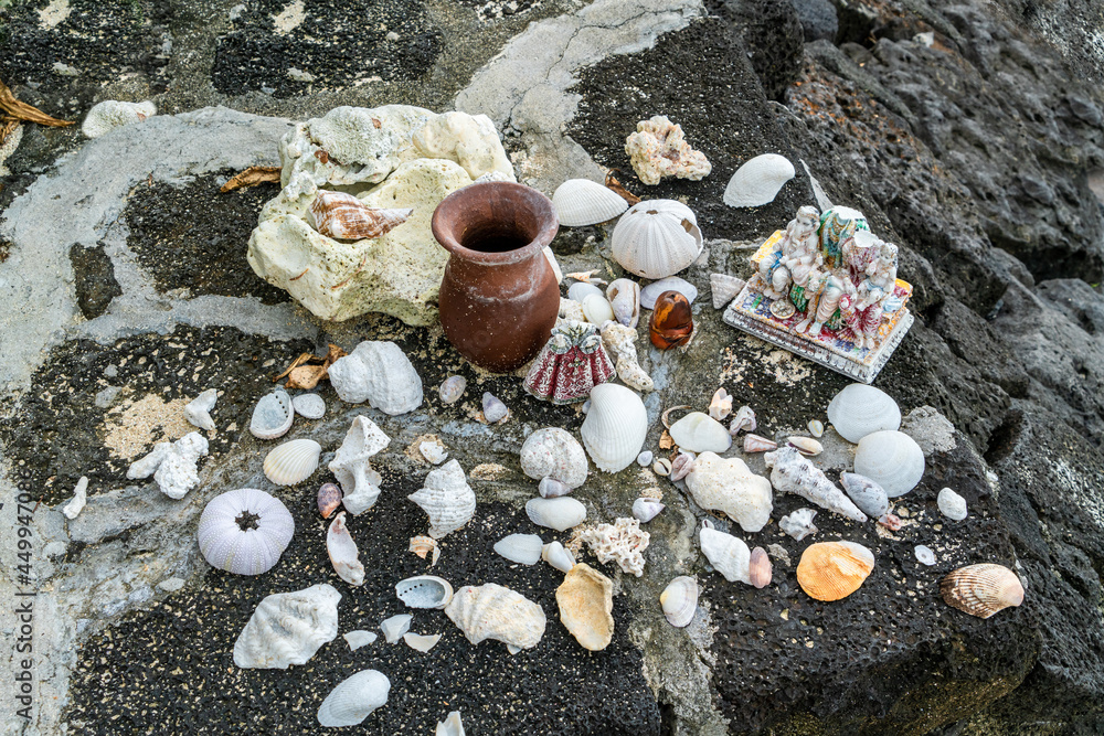 Small souvenirs from Mauritius on the beach, shells, clay vase and a ...