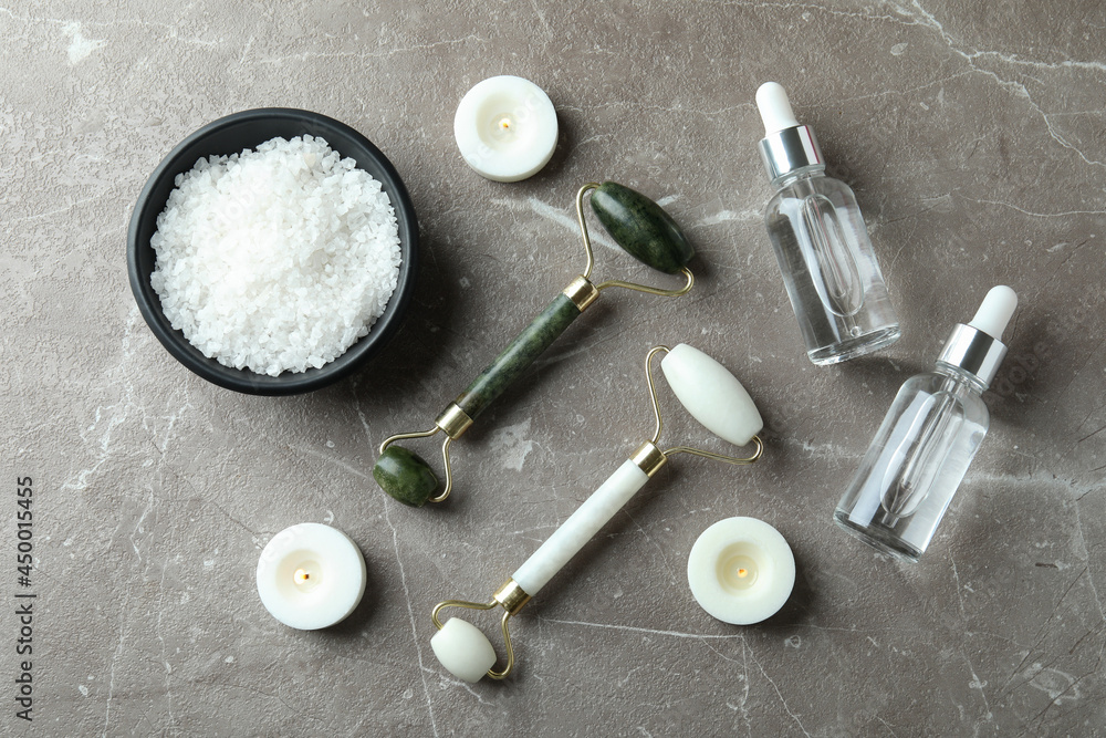 Skin care concept with face rollers on gray textured table Stock Photo ...