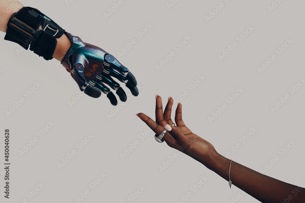 Male hand prosthesis cyborg reaching to female human black african hand ...