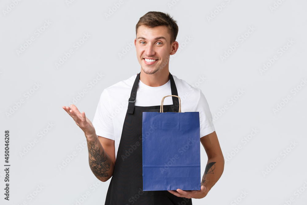 Retail store, shopping and employees concept. Charismatic smiling blond ...