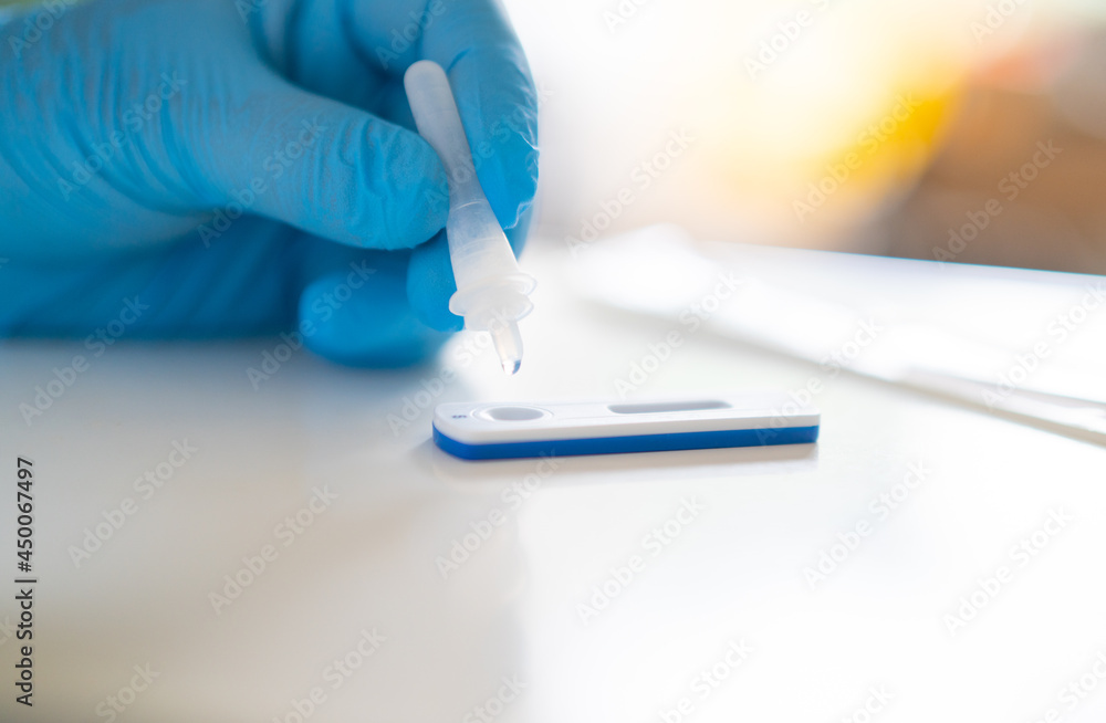 Man using a rapid antigen test kit. Rapid antigen testing is a ...