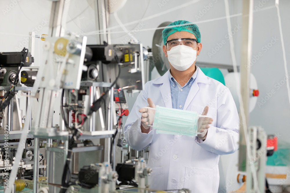 male factory worker are producing medical face masks and checking of ...