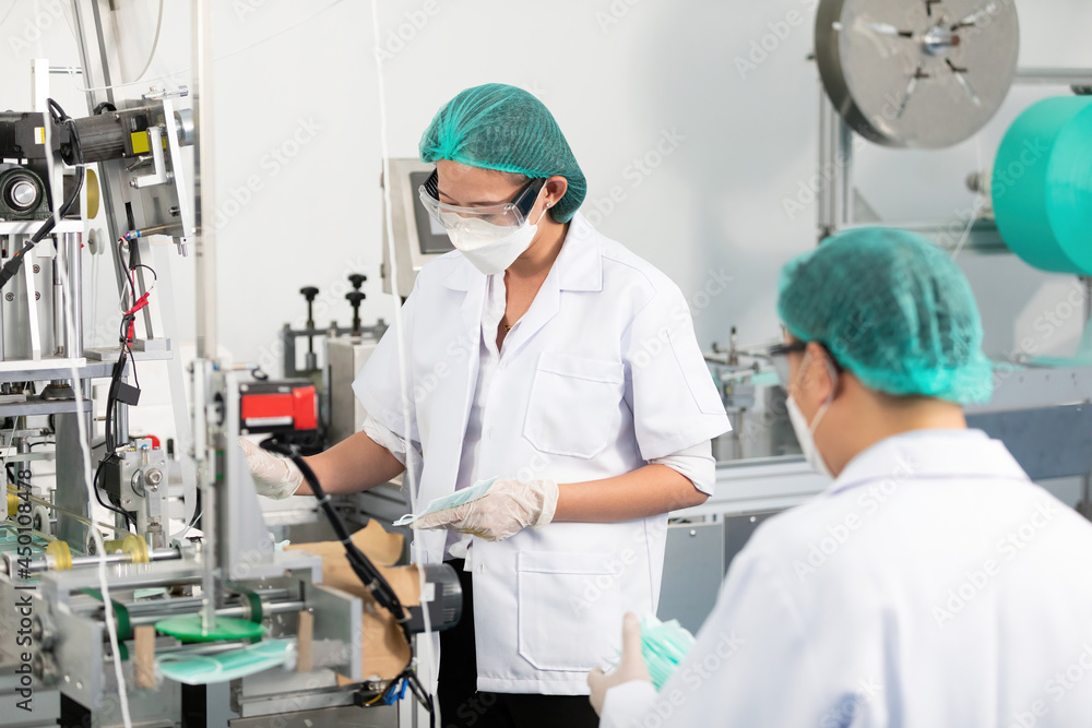 woman factory worker are producing medical face masks talking to ...