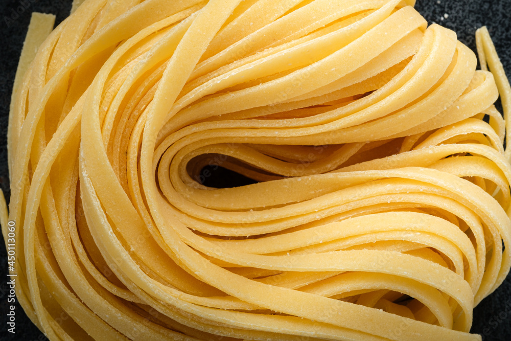 Texture Italian raw pasta rolled into a nest. Food background of ...