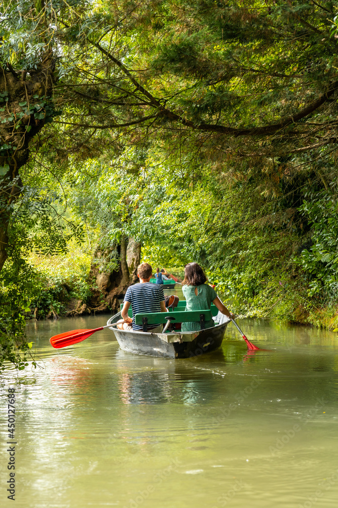 A young couple rowing the boat sailing between La Garette and Coulon ...