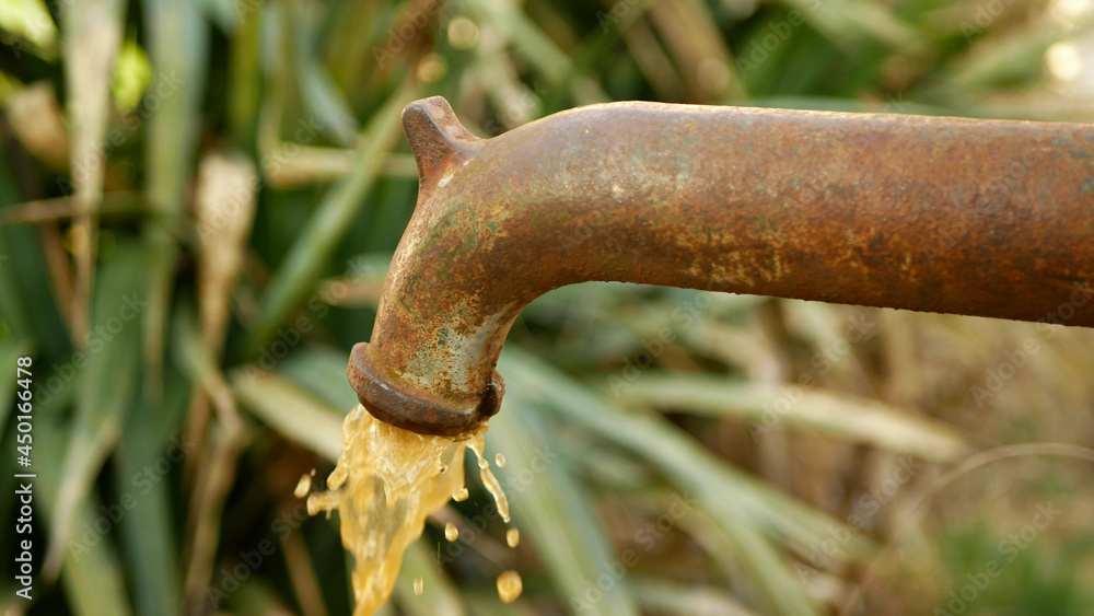 Dirty contaminated water spring water hand well pump outlet with dark ...