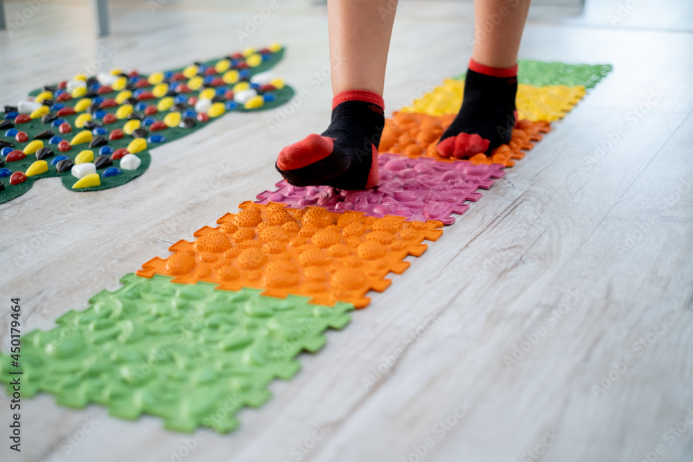 Close up legs stepping on colorful orthopedic mats with different ...