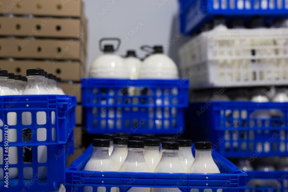 Image of crates of fresh farm cow's milk spilled in plastic bottles ...