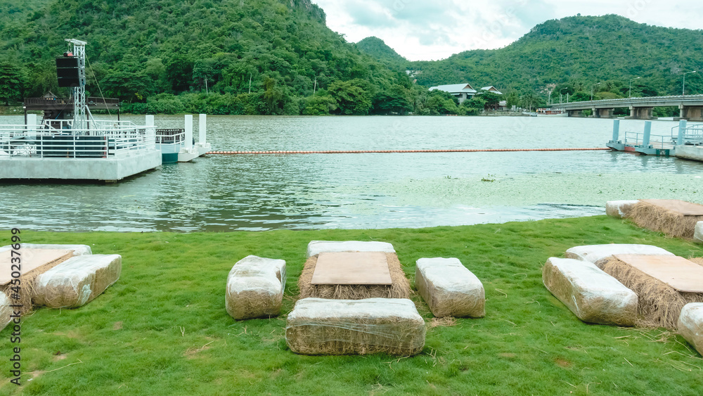 Seats and tables made from straw bales for event and party laid on lawn ...