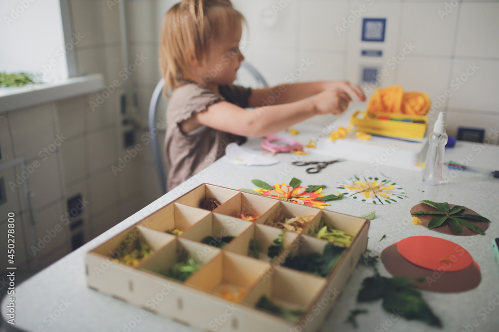 Cute kid exploring leaves and petals at home, child making crafts from ...