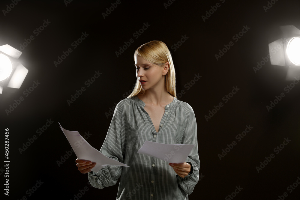 Professional actress reading her script during rehearsal in theatre ...