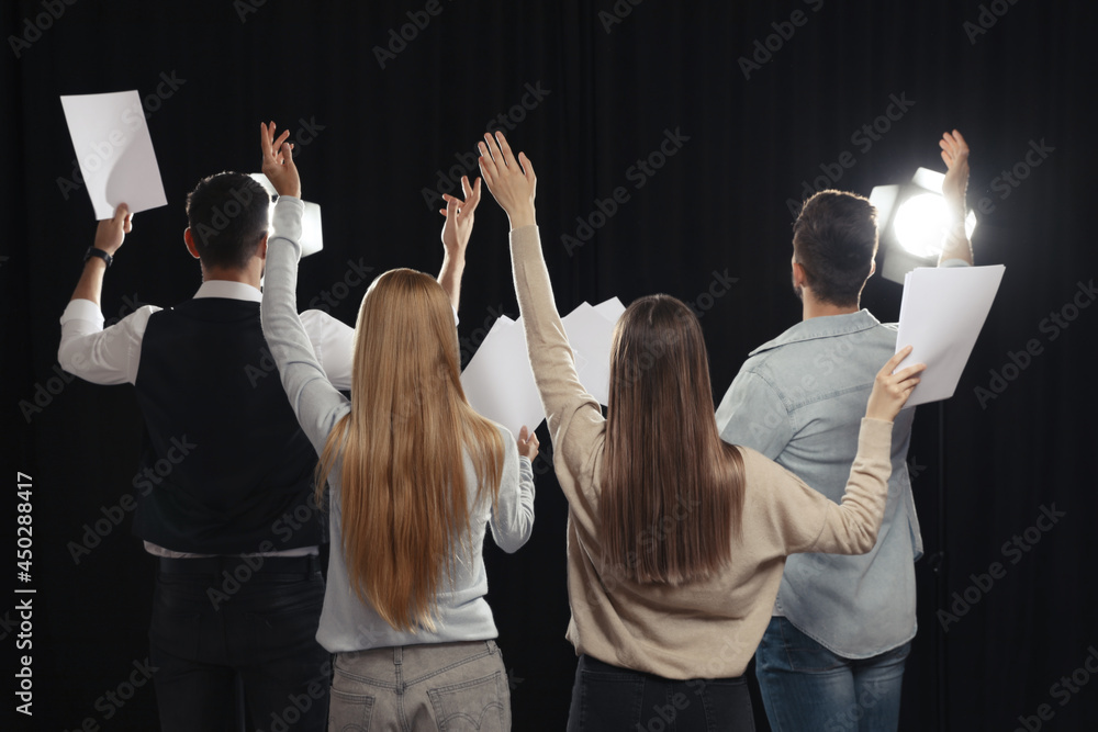 Professional actors bowing on stage in theatre, back view Stock Photo ...