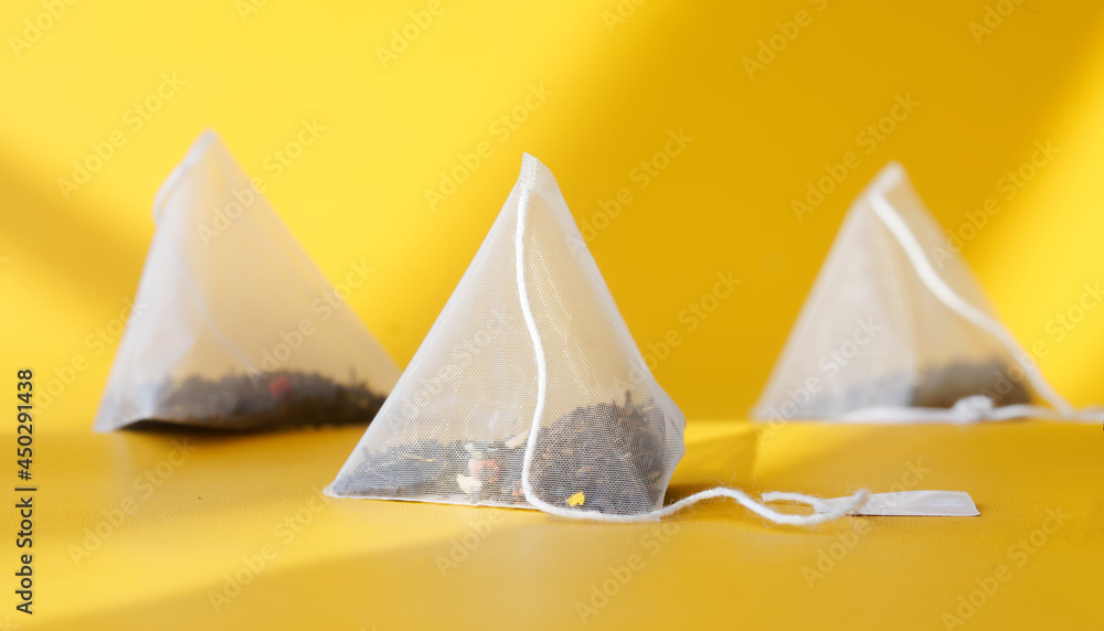 White pyramid tea bags with black and green tea flavored with fruits ...