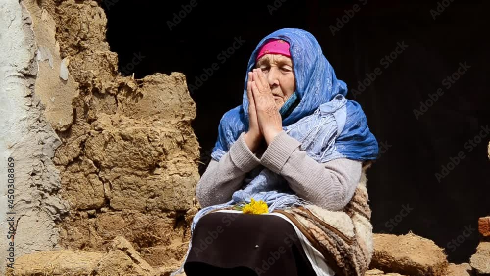 An old grandmother in prayer. The old grandmother is praying ...