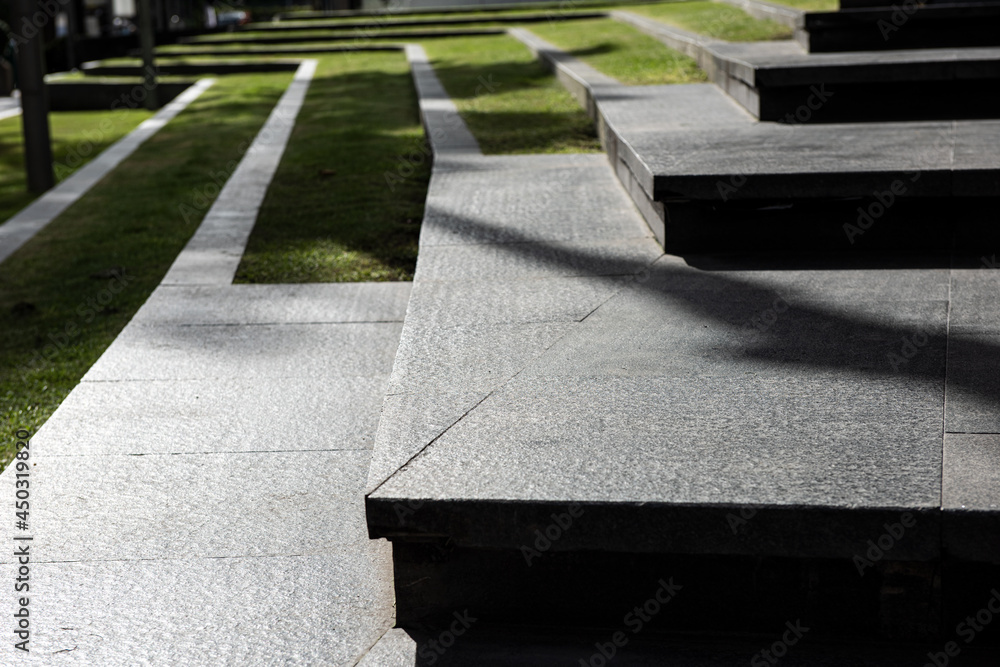 Neat and tidy grey stair steps made of stone and granite tiles with a ...