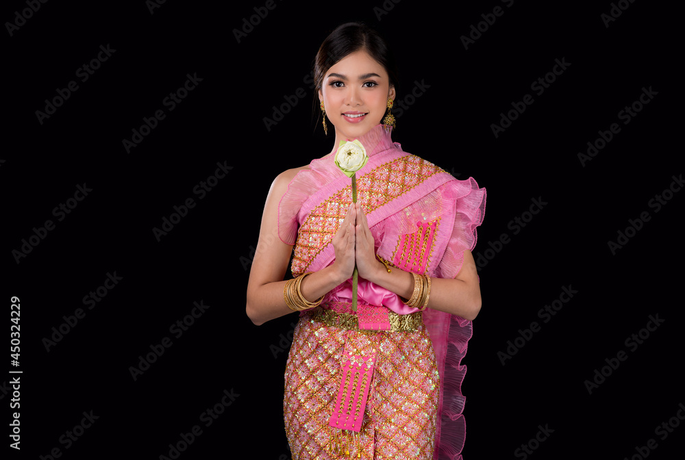Portrait of an Asian woman wearing a beautiful Thai dress on a white ...